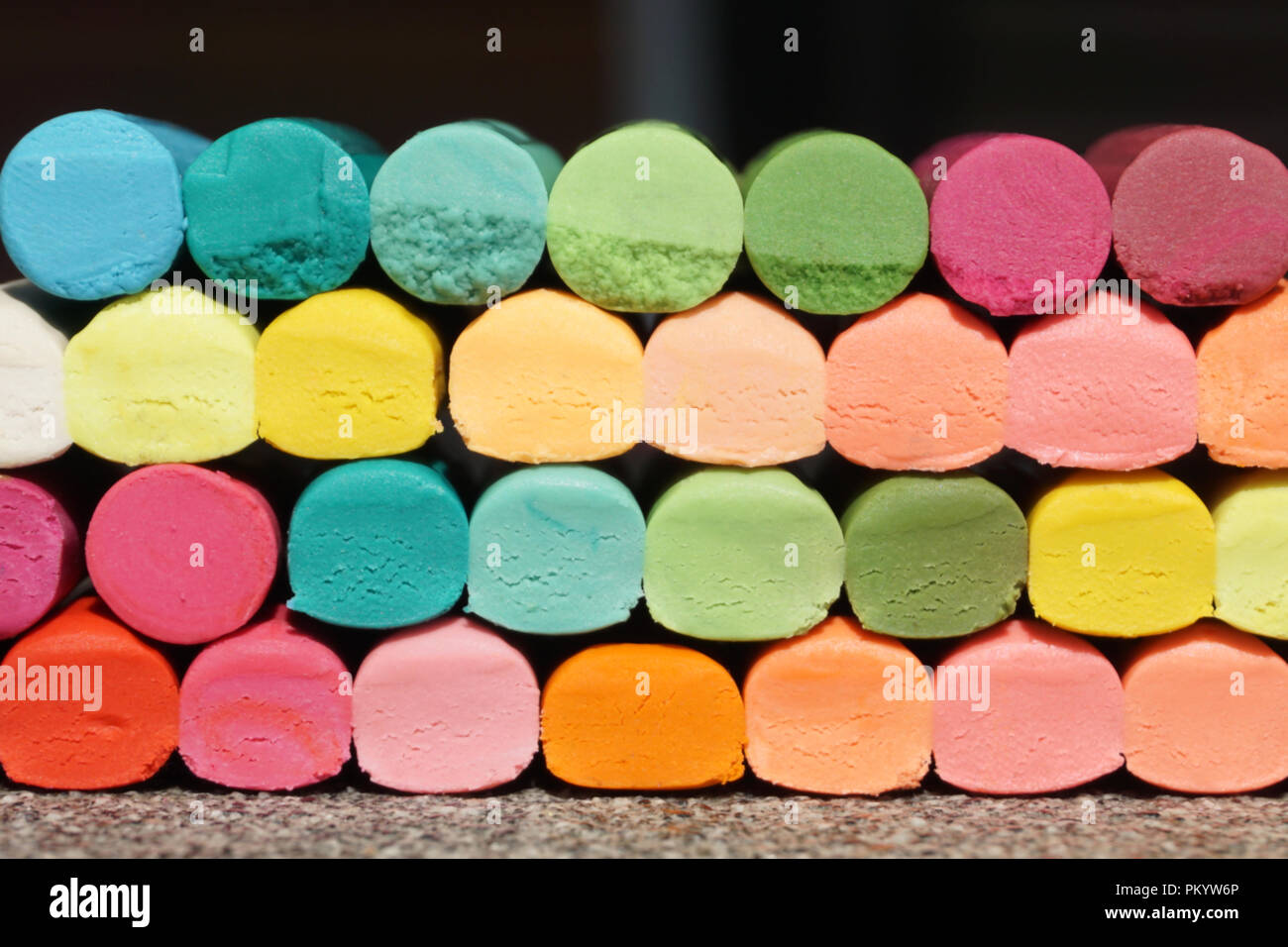 Vivid multicolor craft stick pencils stacked up with close up textured ...
