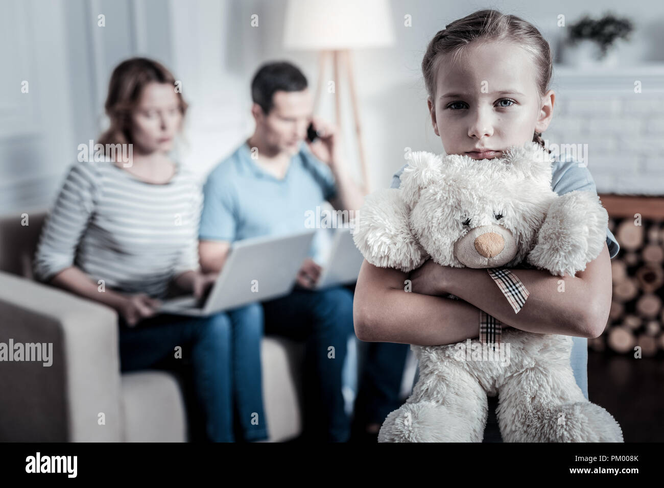 Sad kind hugging a toy Stock Photo - Alamy
