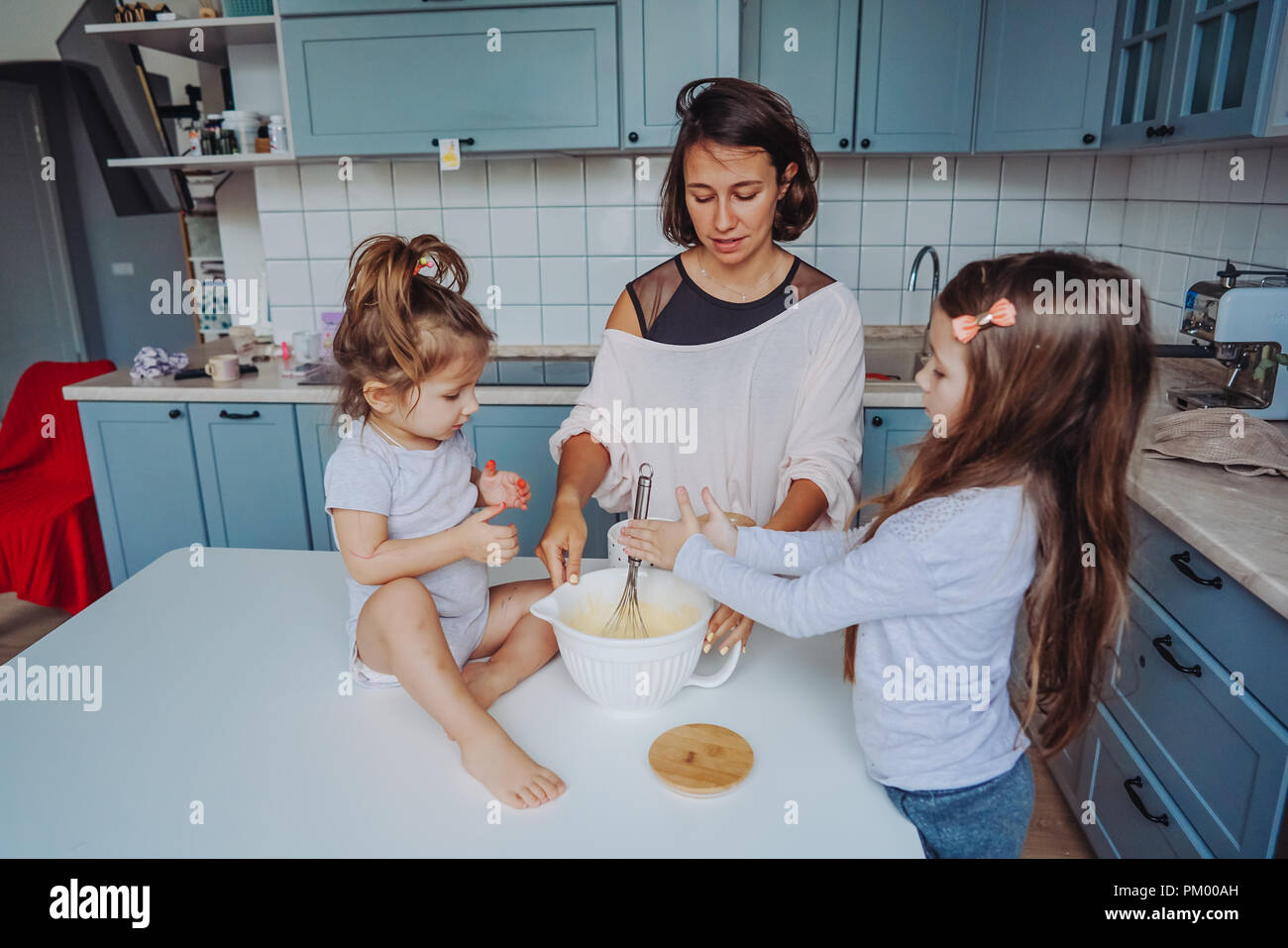 Happy family cook together in the kitchen Stock Photo - Alamy
