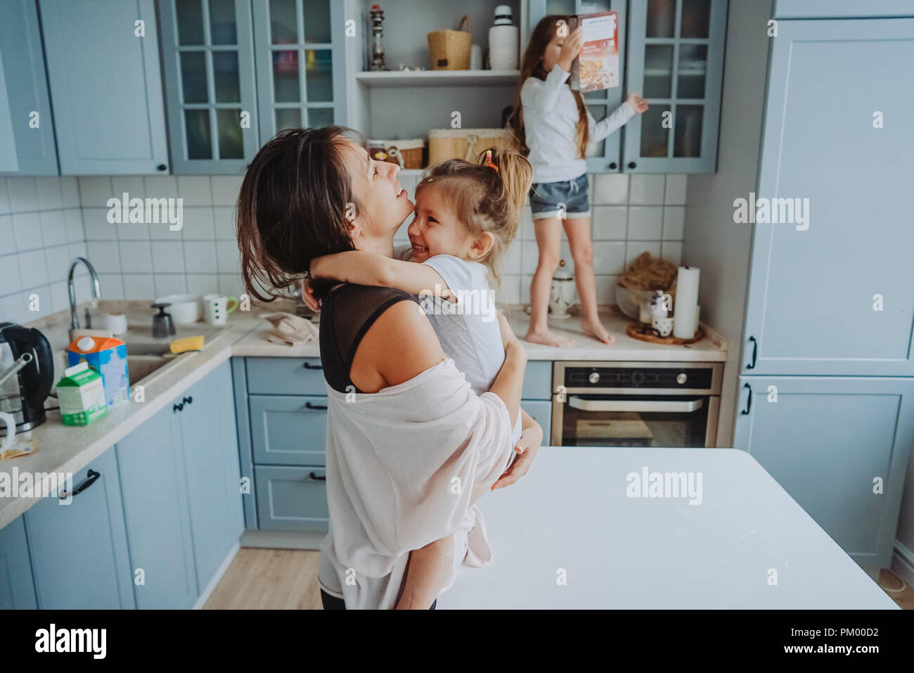 Happy family having fun in the kitchen Stock Photo - Alamy