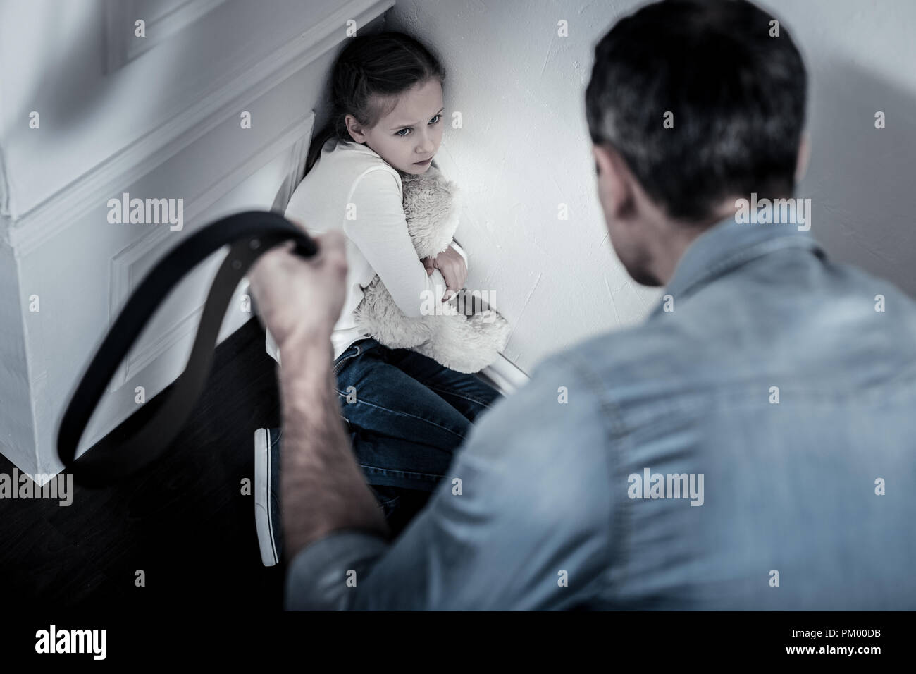 Defenseless kid sitting on the floor Stock Photo - Alamy