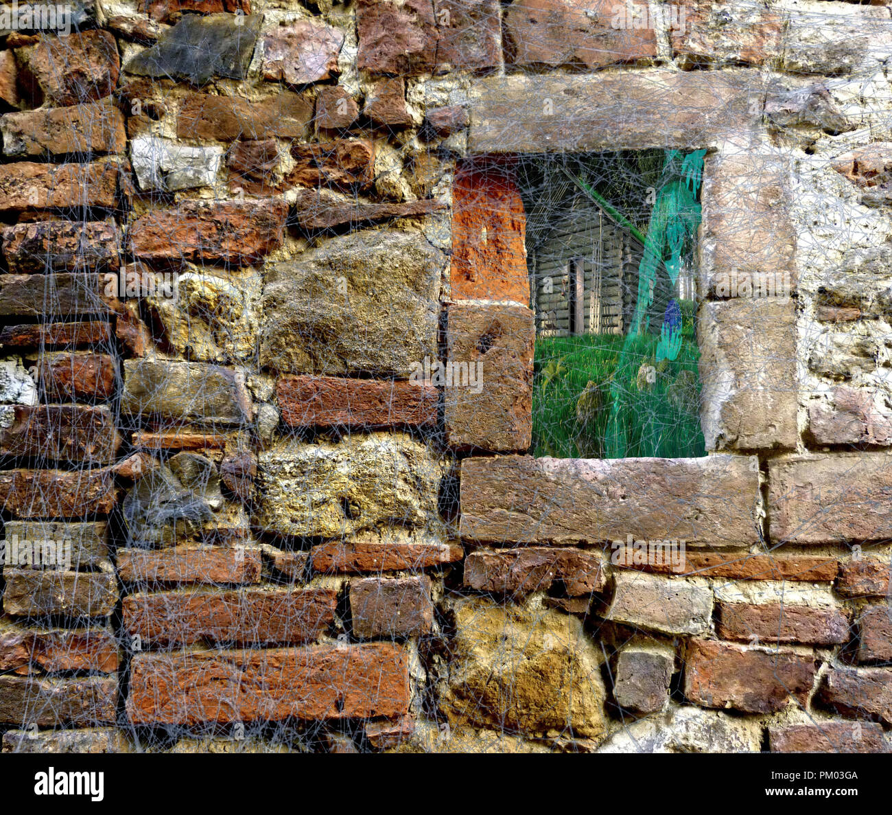 halloween brick wall covered in spider web rags with window looking on ...