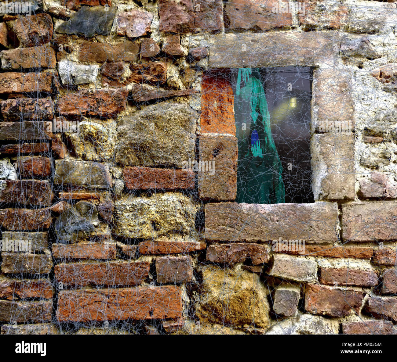 Halloween stone brick wall covered in spider web rags with a window ...