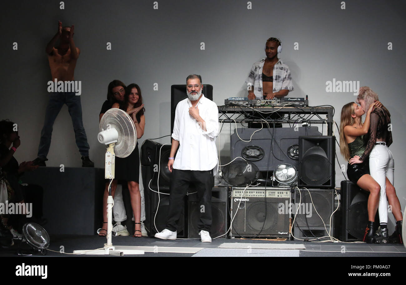 Fashion designer Ashish Gupta acknowledges the audience following his ...