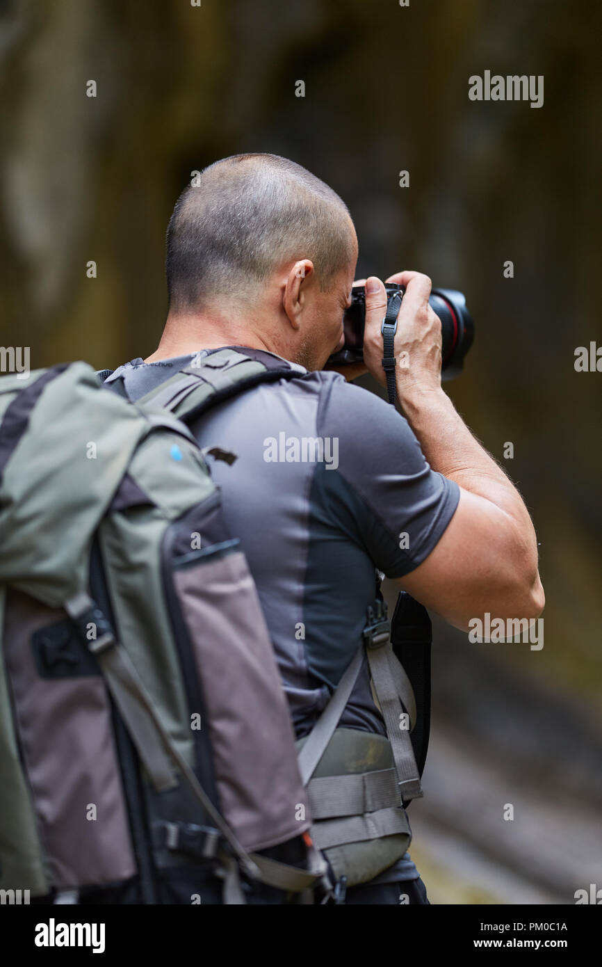 Photographer with professional camera taking pictures outdoor Stock ...