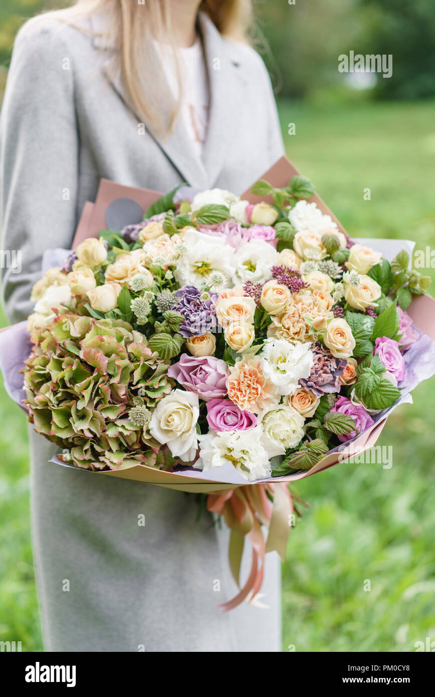 beautiful spring bouquet in hands. delicate flower arrangement with ...