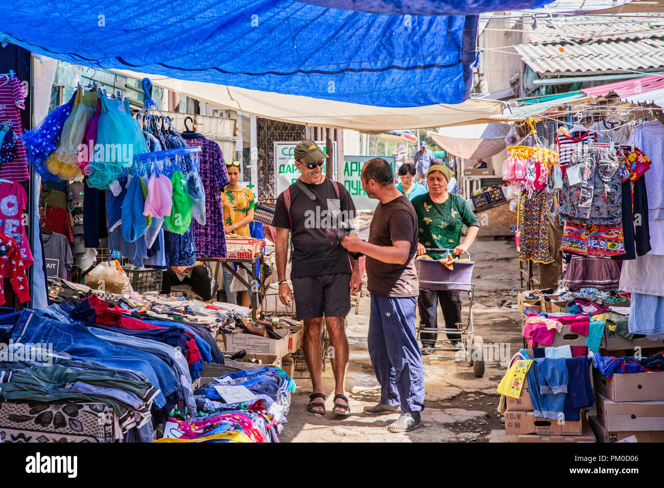 Local Kyrgyz man greeting and shaking hands with a tourist in the Big ...
