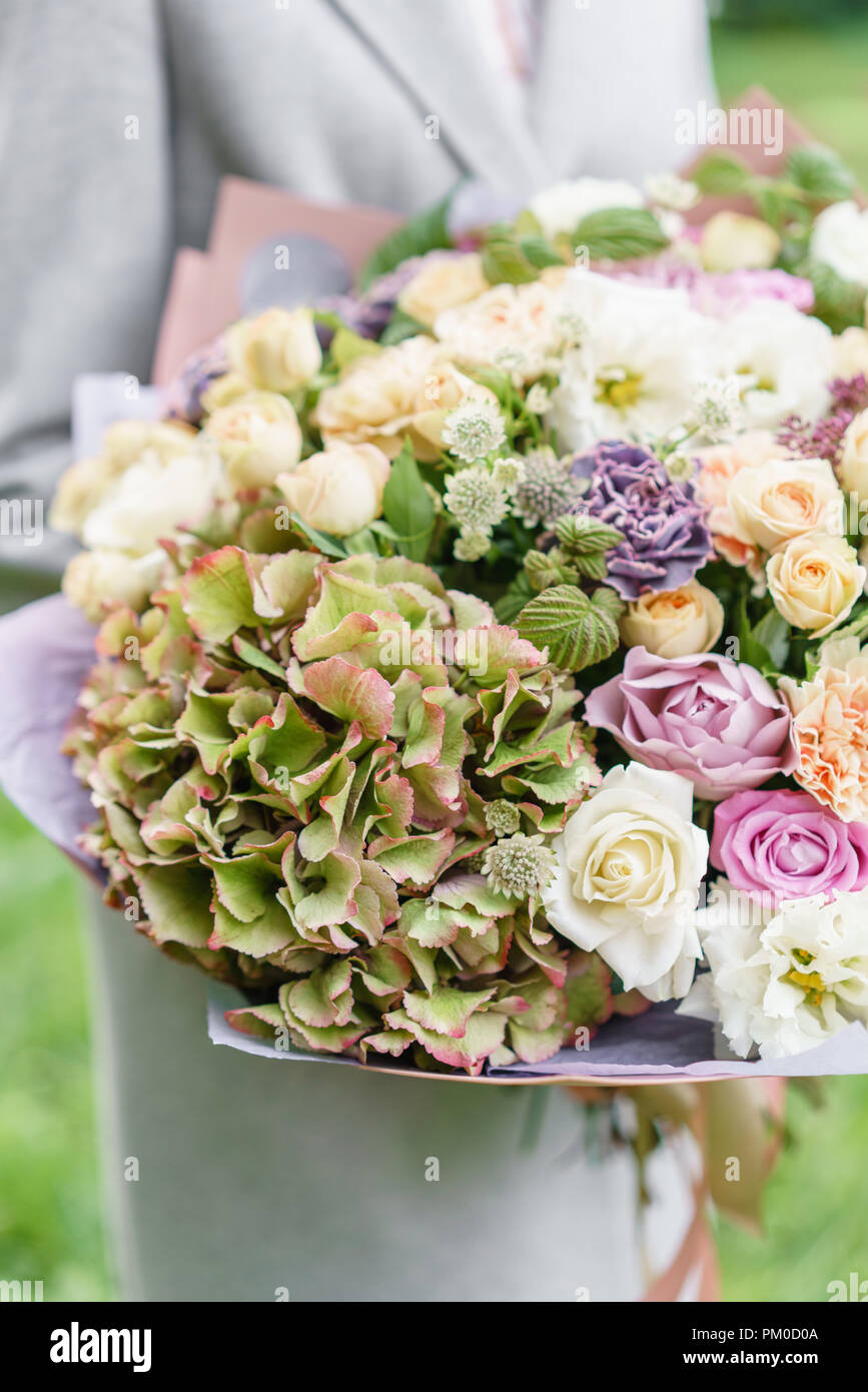 beautiful spring bouquet in hands. delicate flower arrangement with ...