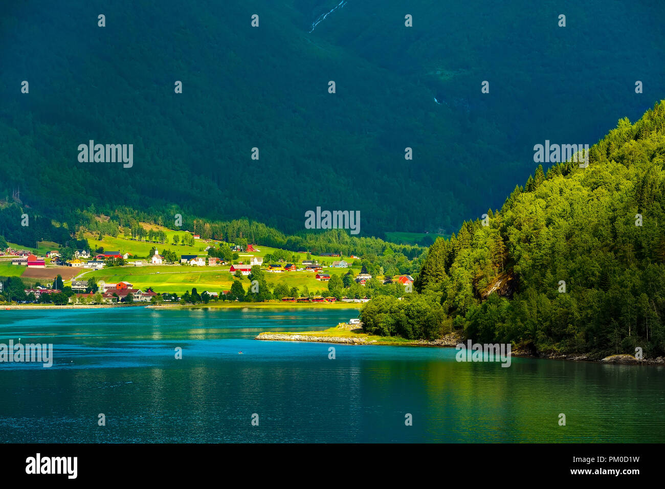 Norwegian village landscape with fjord, mountains and colorful houses ...