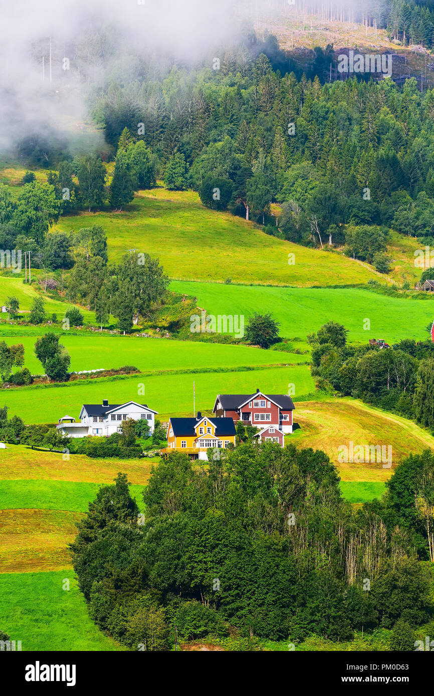 Norwegian fjord village landscape with mountains, fog clouds and ...