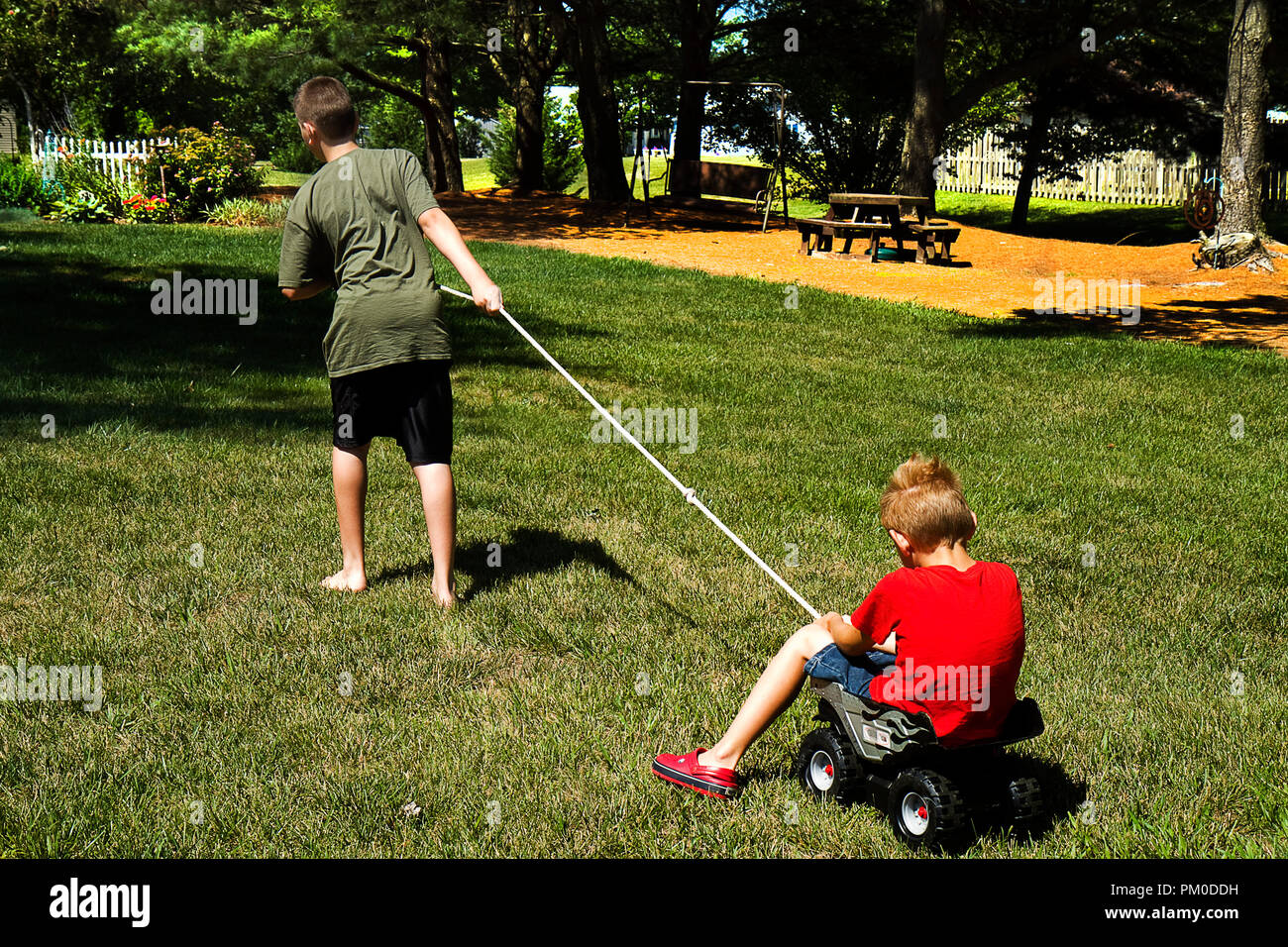Two young boys playing outside without the use of technology. One ...