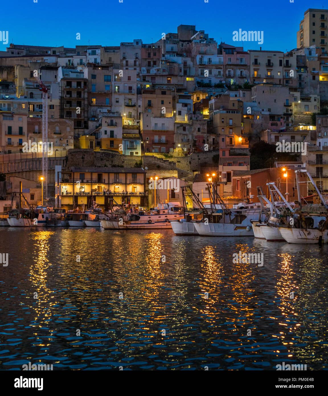 The picturesque city of Sciacca in the evening overlooking its harbour ...