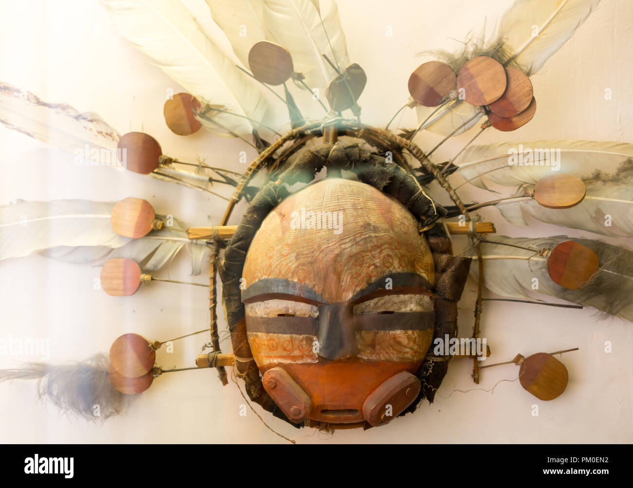Mask ritual from a tree, decorated with paints on a white background ...