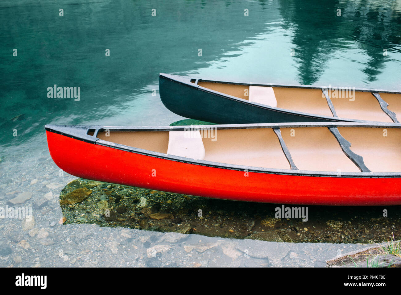 Two canoes floating peacefully on the clear Lake Champex, Switzerland ...
