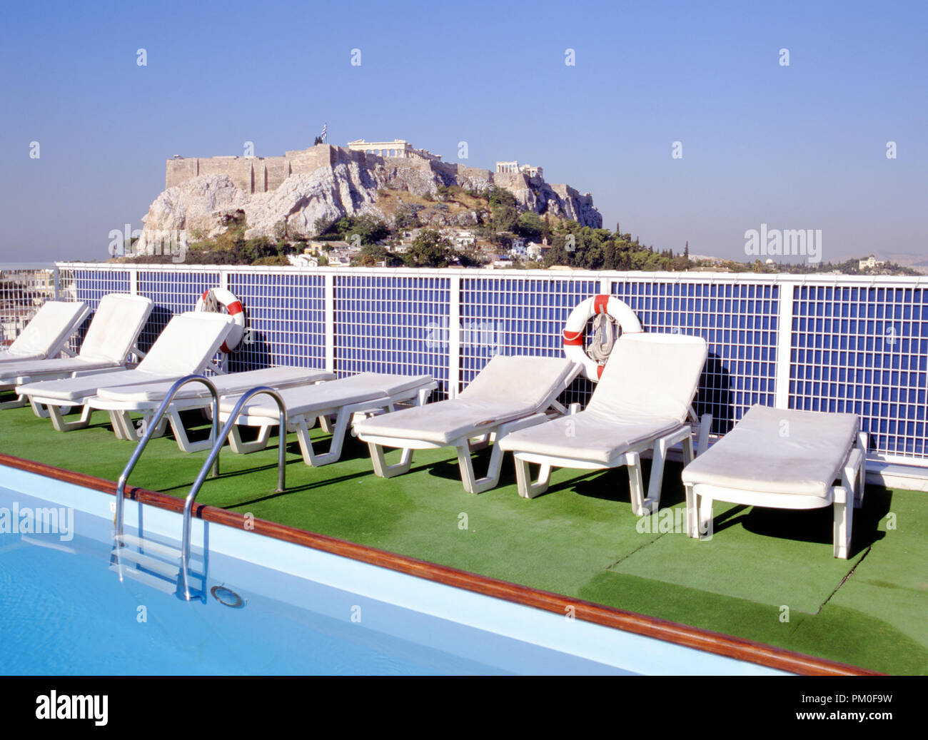 ATHENS, GREECE-MAY 12, 2015: Acropolis in Athens; in front swimming ...