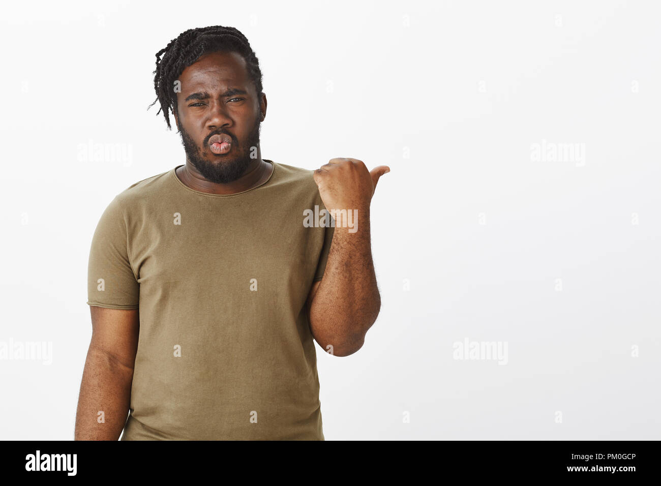 Portrait of shocked questioned attractive african man in casual outfit ...
