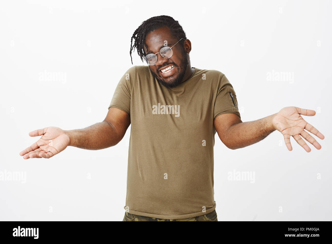Indoor shot of good-looking careless african-american with beard and ...