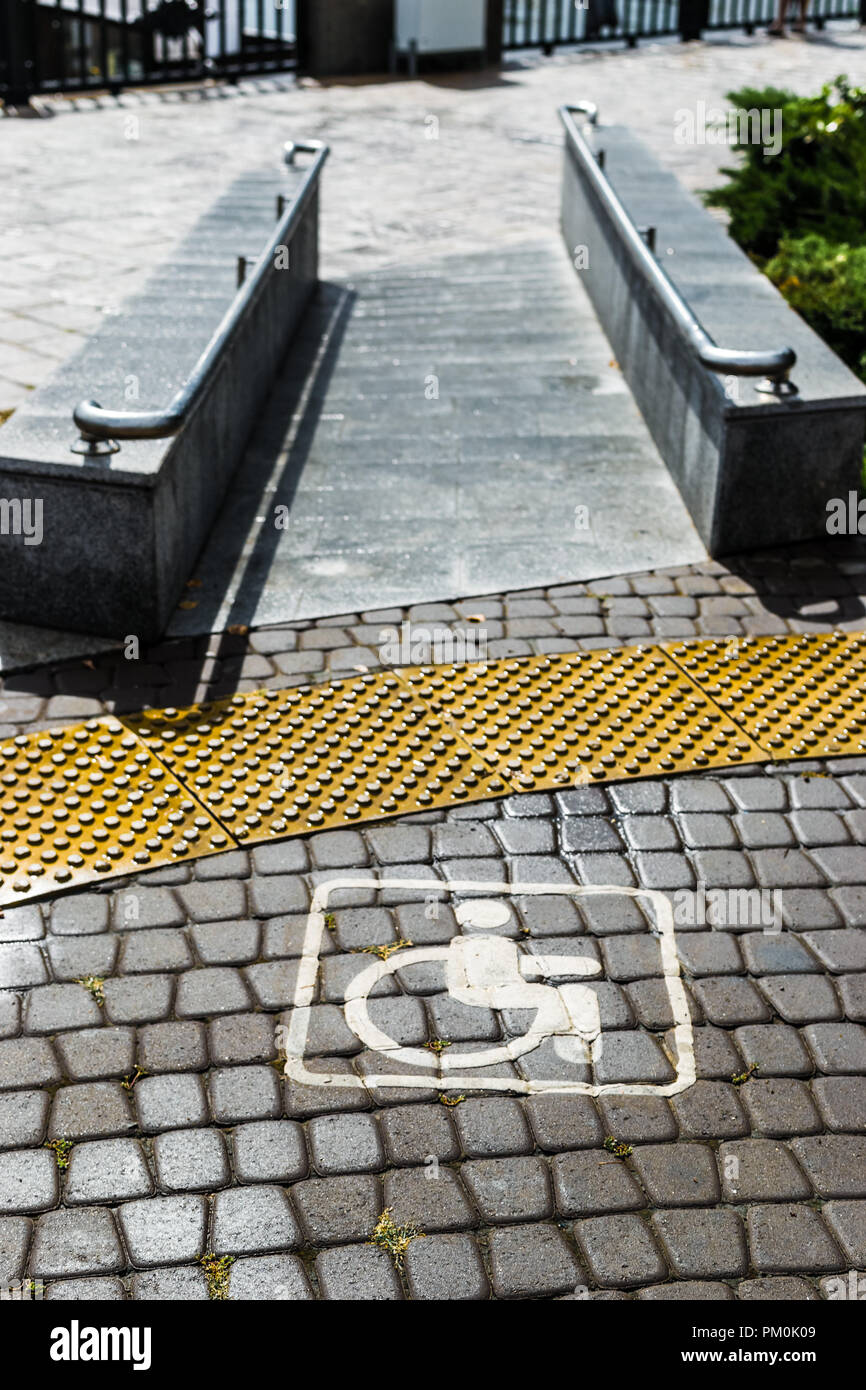 sign, warning, about the path descent for the disabled Stock Photo - Alamy