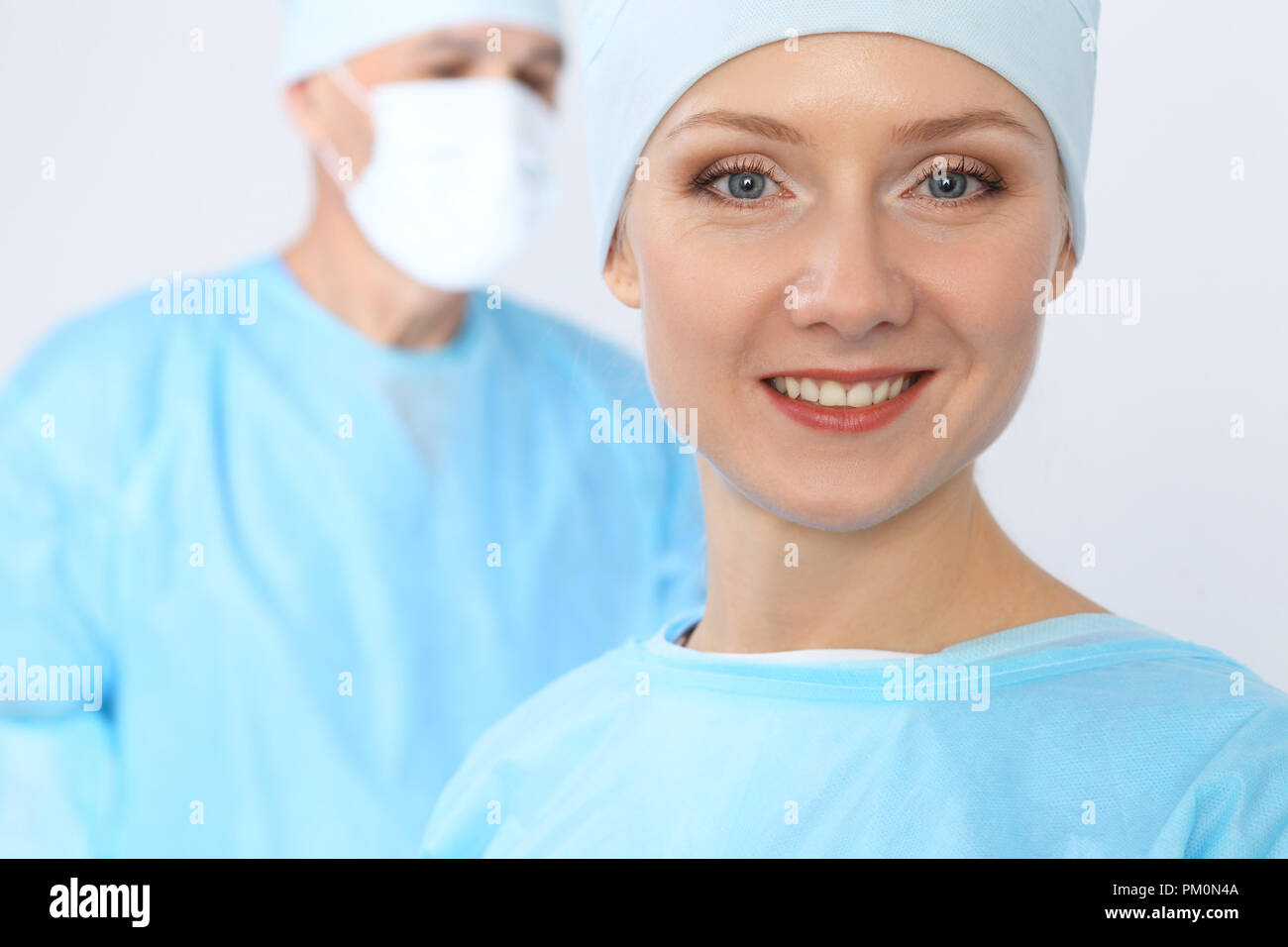 Boss surgeon is examining the operation while medical team are busy of ...