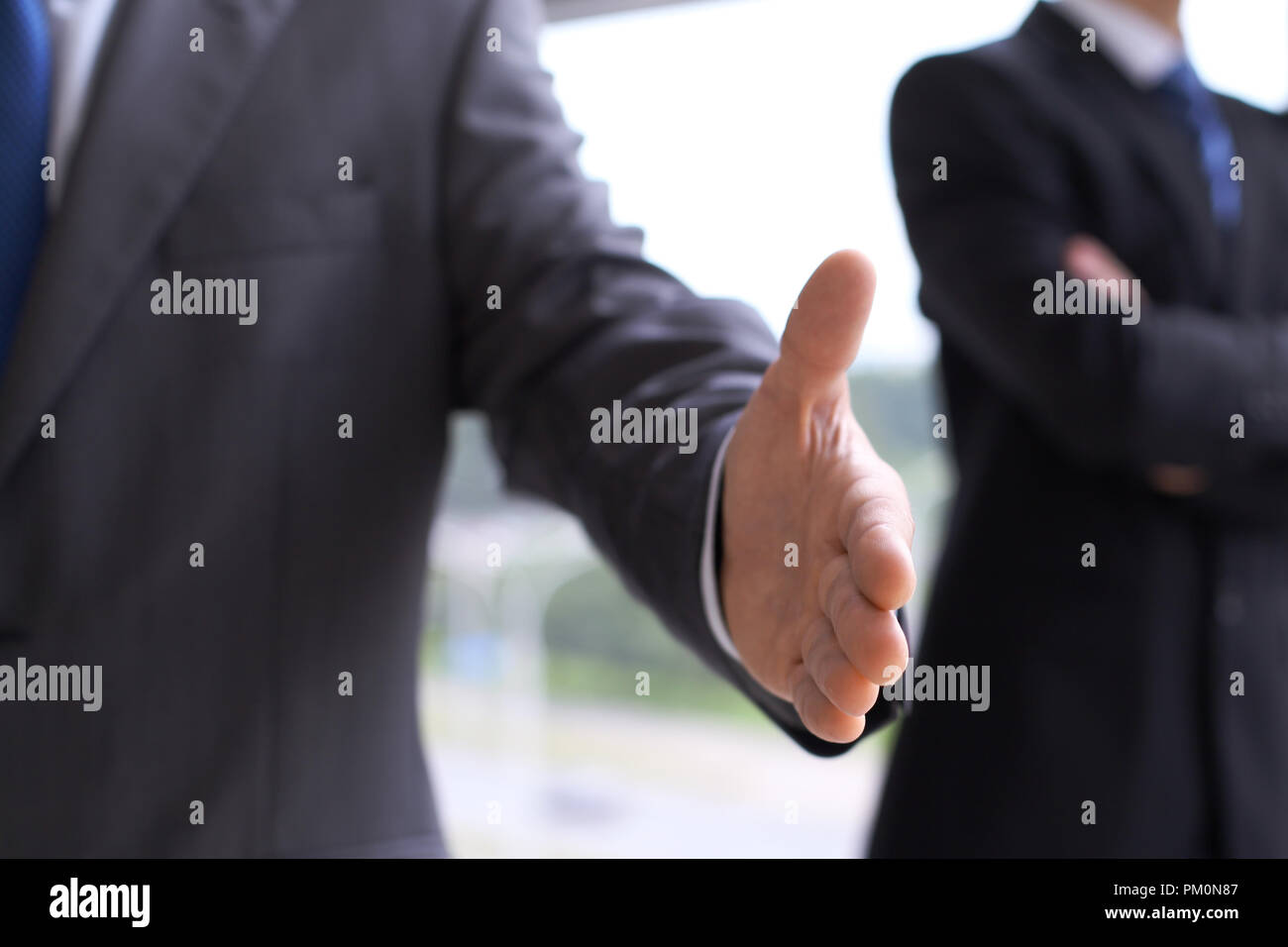 Unknown business man offering handshake while standing straight ...