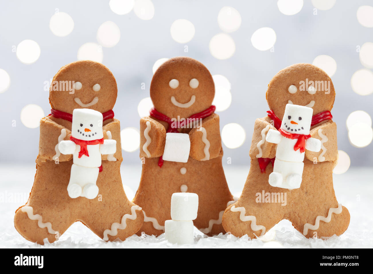 Funny Gingerbread cookie men with tiny marshmallow snowman Stock Photo ...