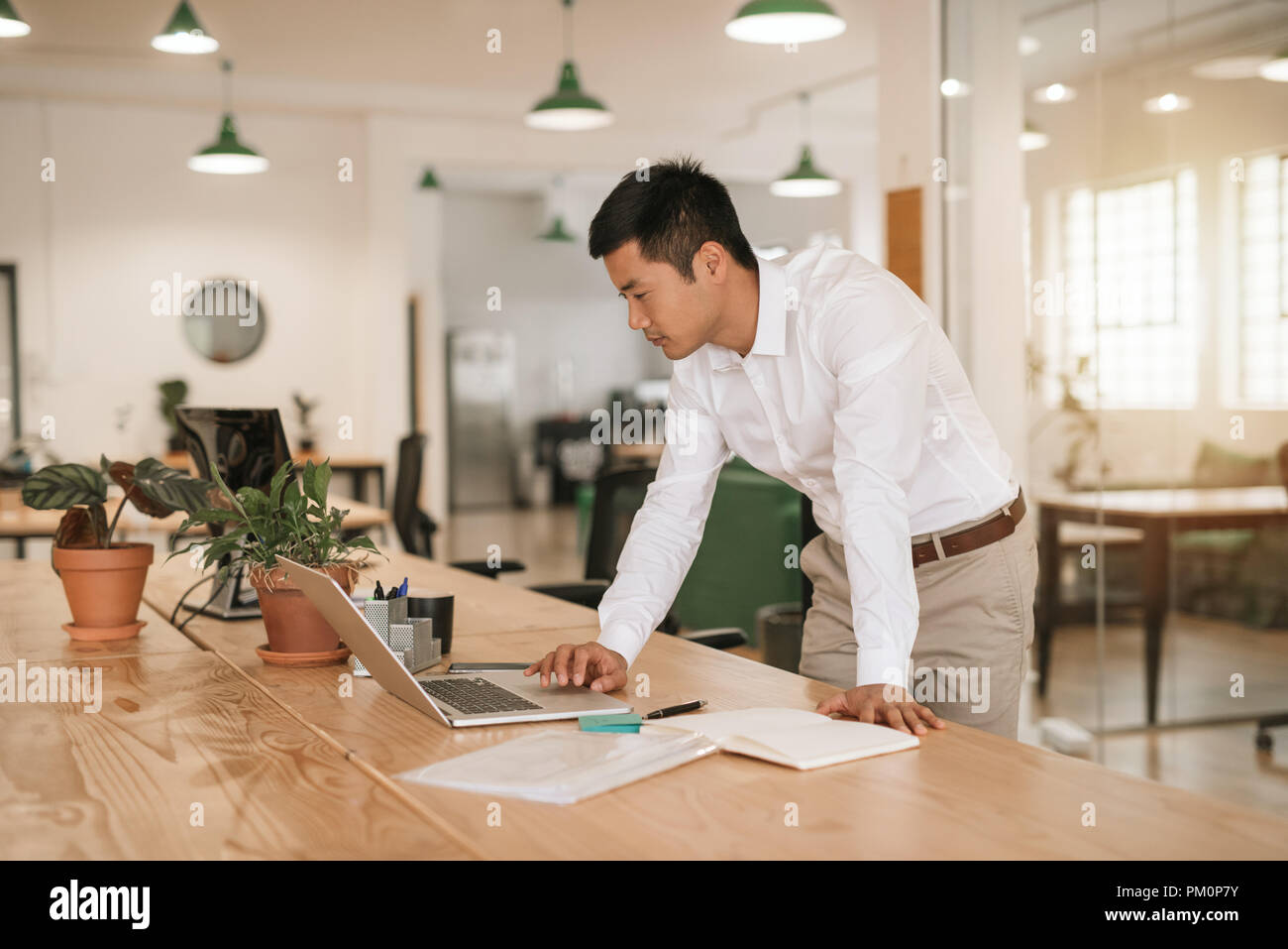 Business a man standing over a desk hi-res stock photography and images ...