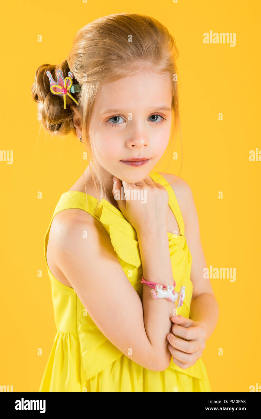 Girl posing on yellow background Stock Photo - Alamy