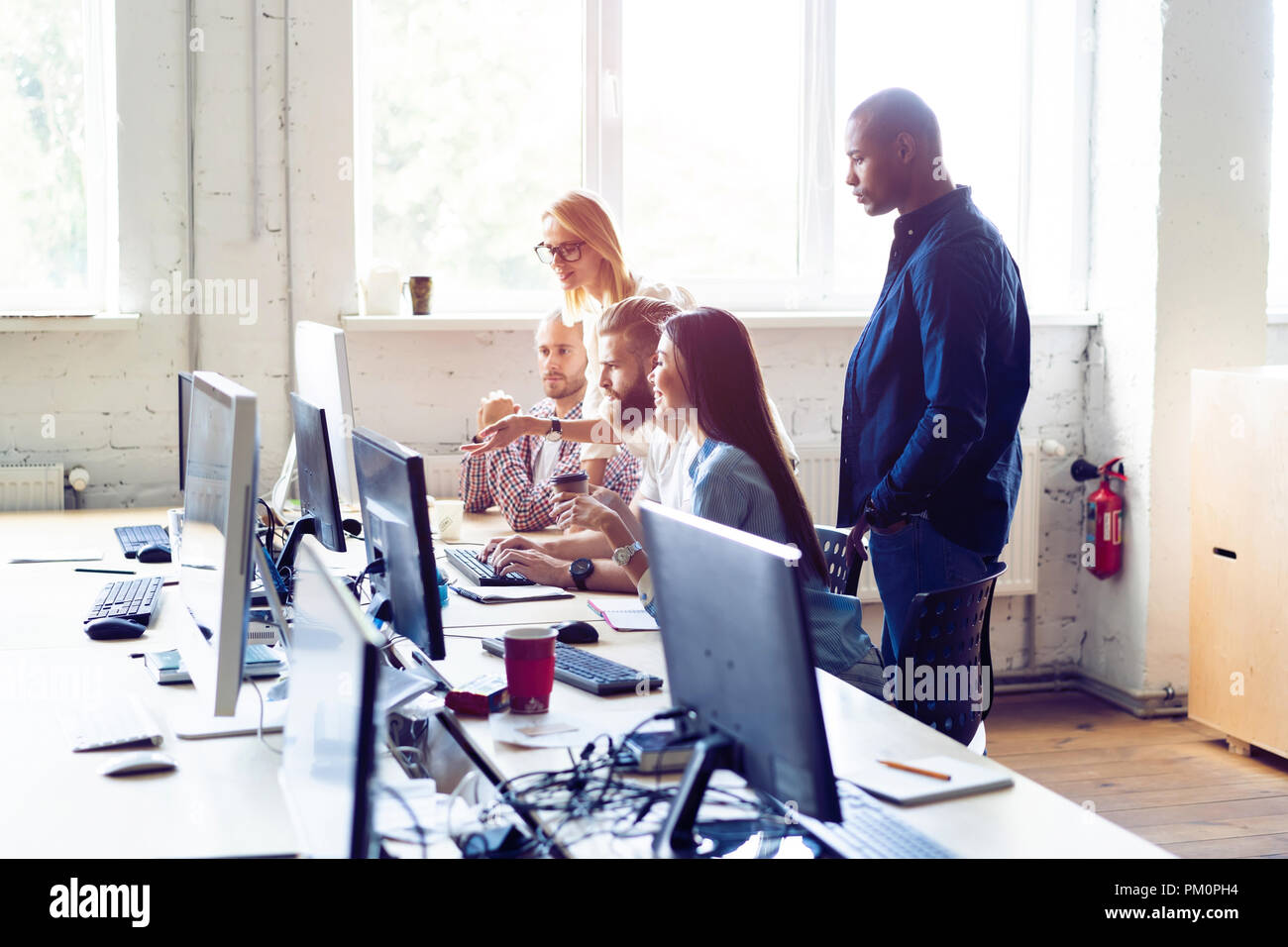 Creative office. Young modern colleagues in smart casual wear working ...