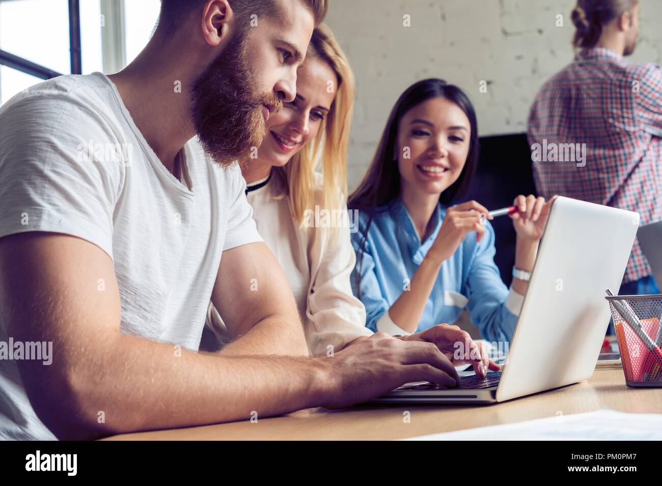 Beautiful business people using gadgets, studying documents, talking ...