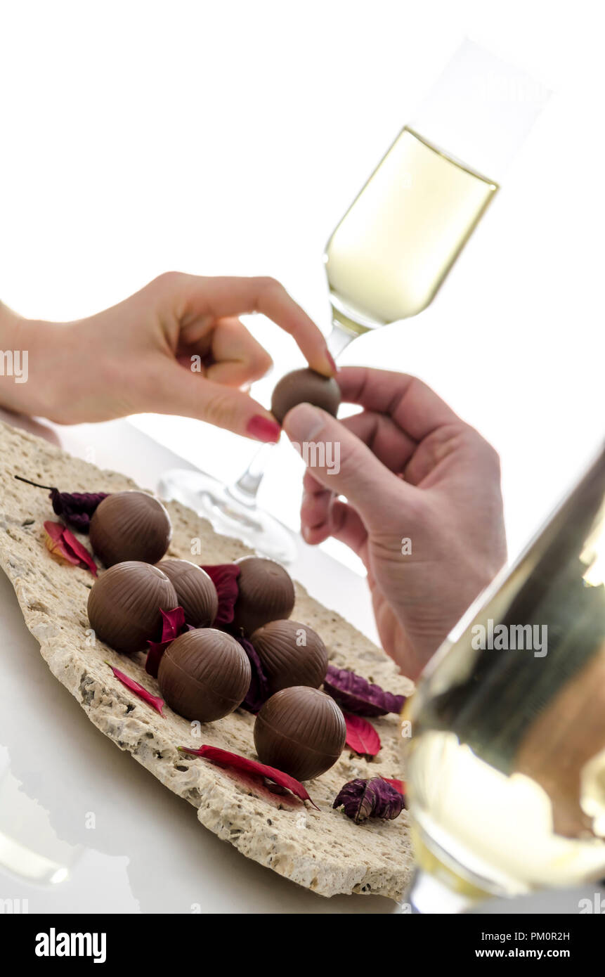 Cropped view of a couple sharing a chocolate candy Stock Photo - Alamy