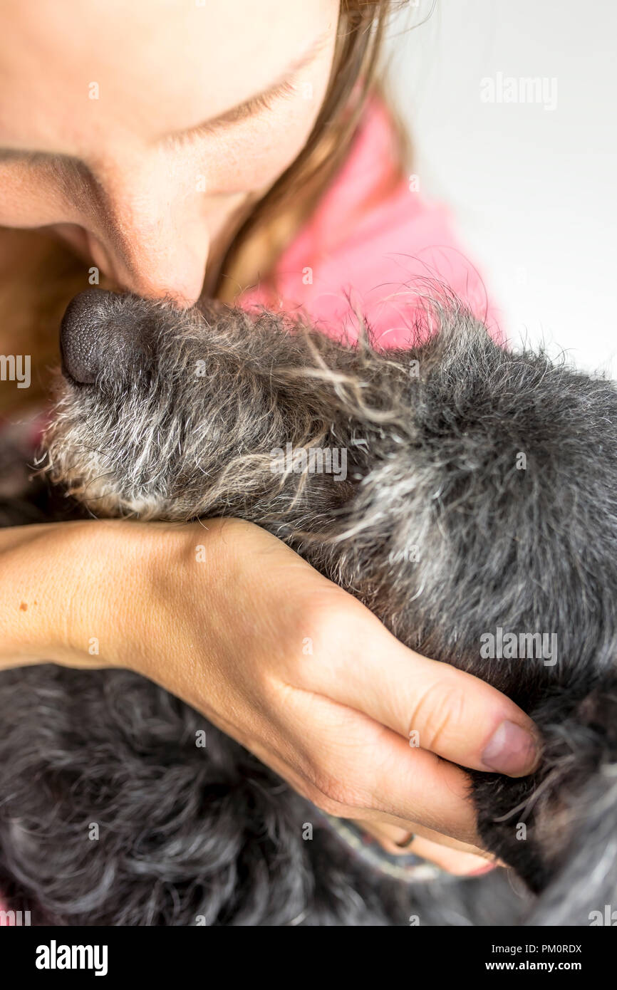 Young woman cuddling with her dog. Concept of friendship between dog ...