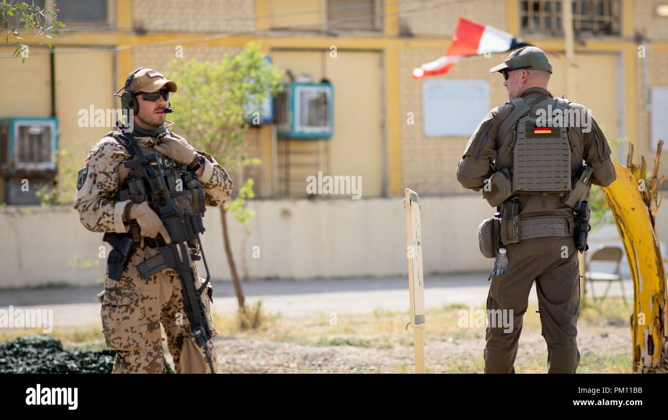 Taji, Iraq. 16th Sep, 2018. A heavily armed German soldier (L) and an ...