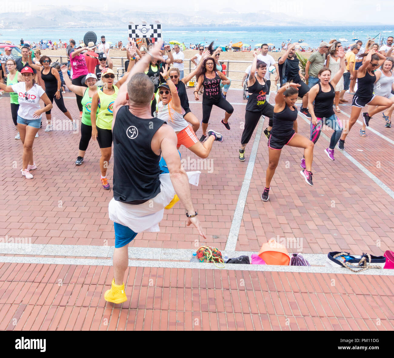Zumba class overlooking beach in Spain Stock Photo - Alamy