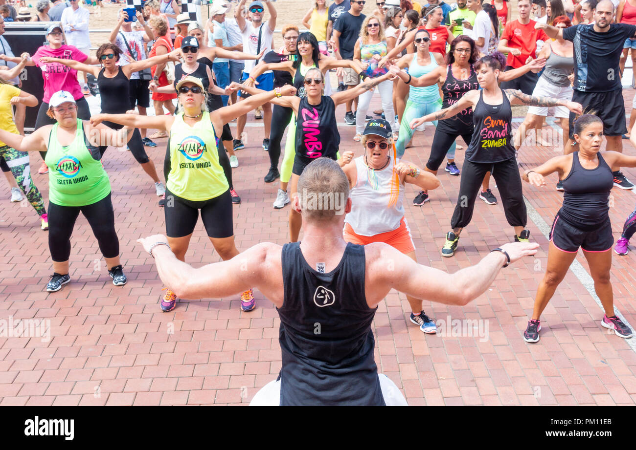Zumba class overlooking beach in Spain Stock Photo - Alamy