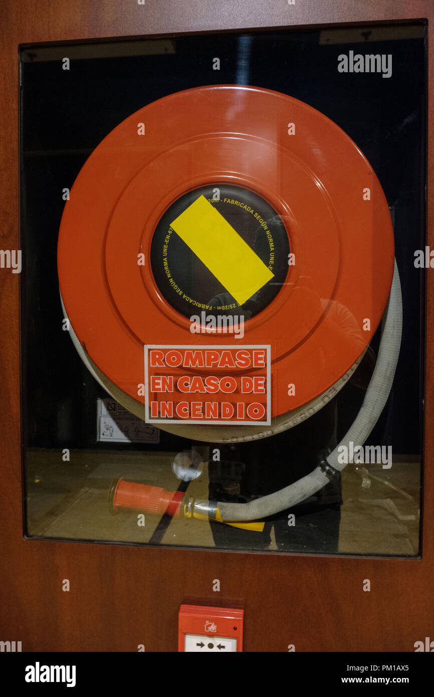 fire hose inside your glass box inside a building Stock Photo - Alamy