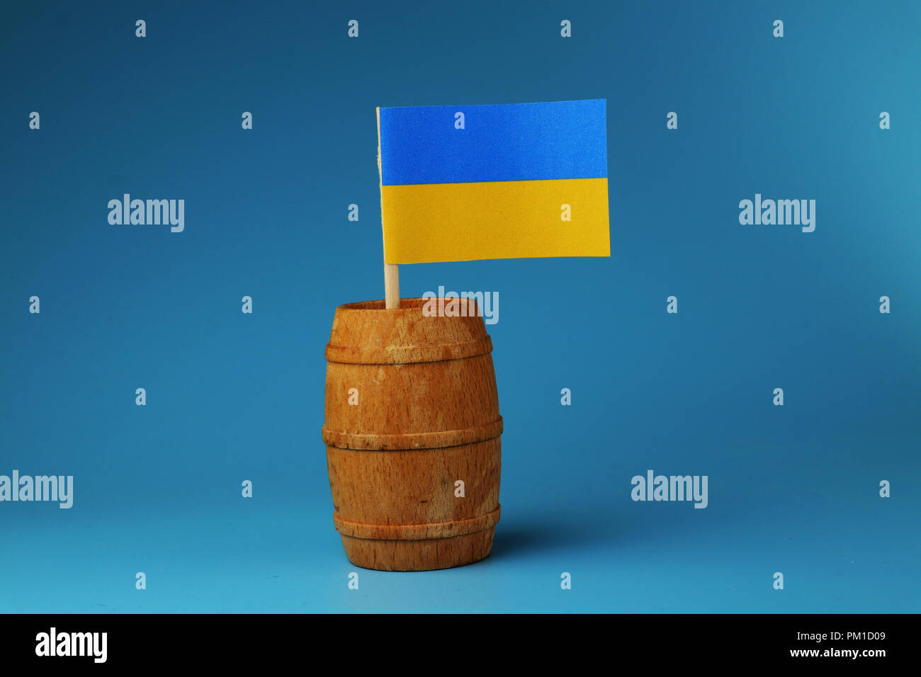 A beautiful paper flag of Ukraine on wooden stick in wooden barrel ...