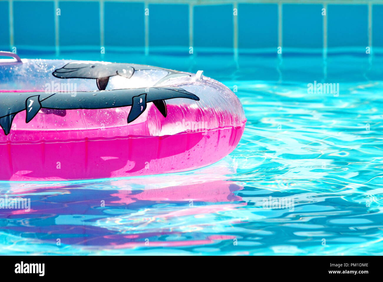 Pink inflatable round tube in swimming pool Stock Photo - Alamy