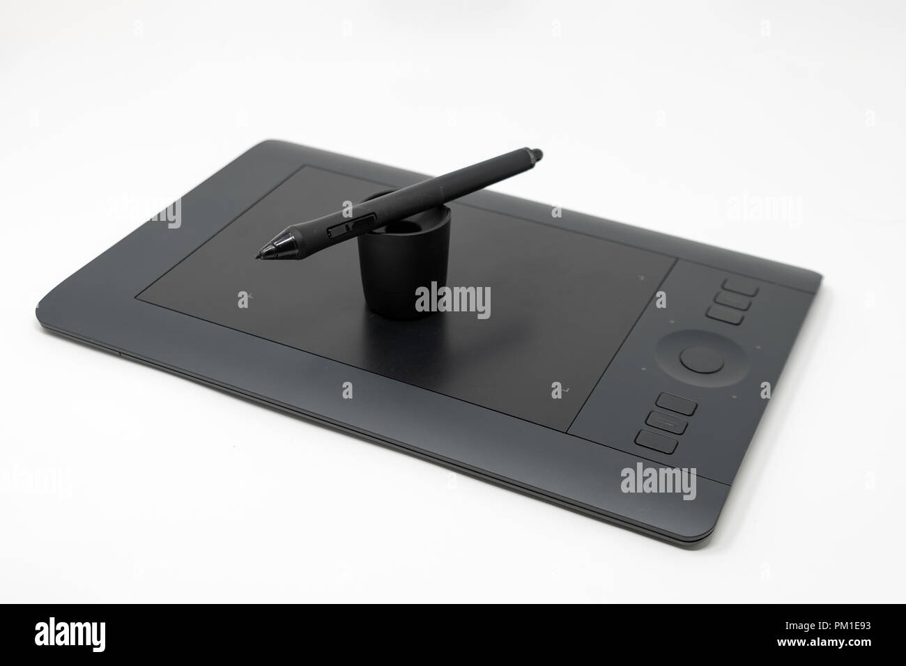 A debadged graphics tablet and digital stylus set against a white ...