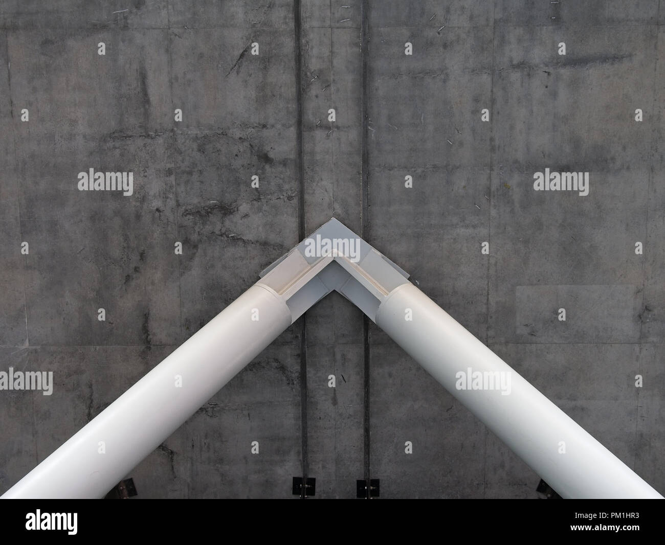 White steel structural support pillars and gray concrete. Abstract ...