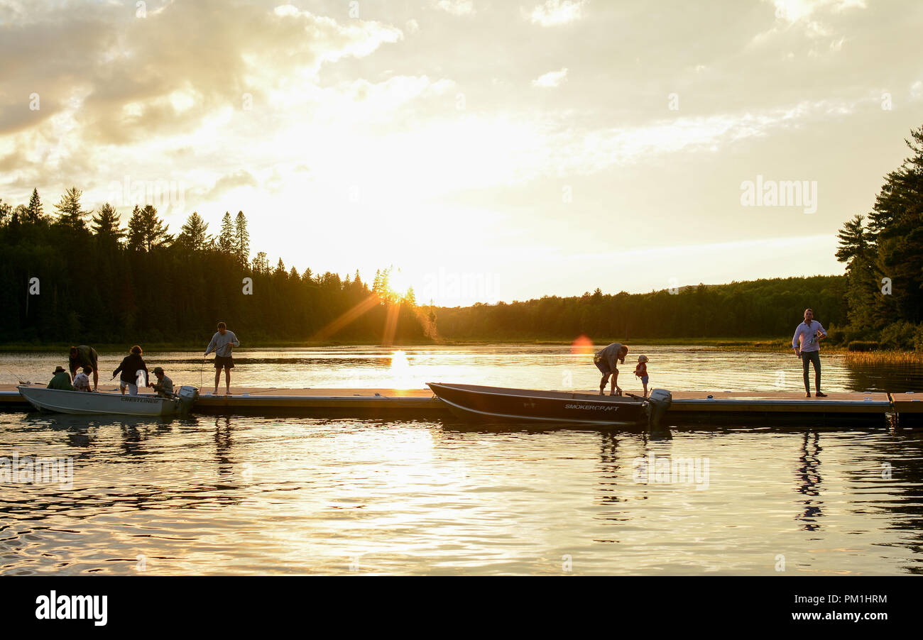 people walking on boat dock sunset landscape getting out of boats Stock ...
