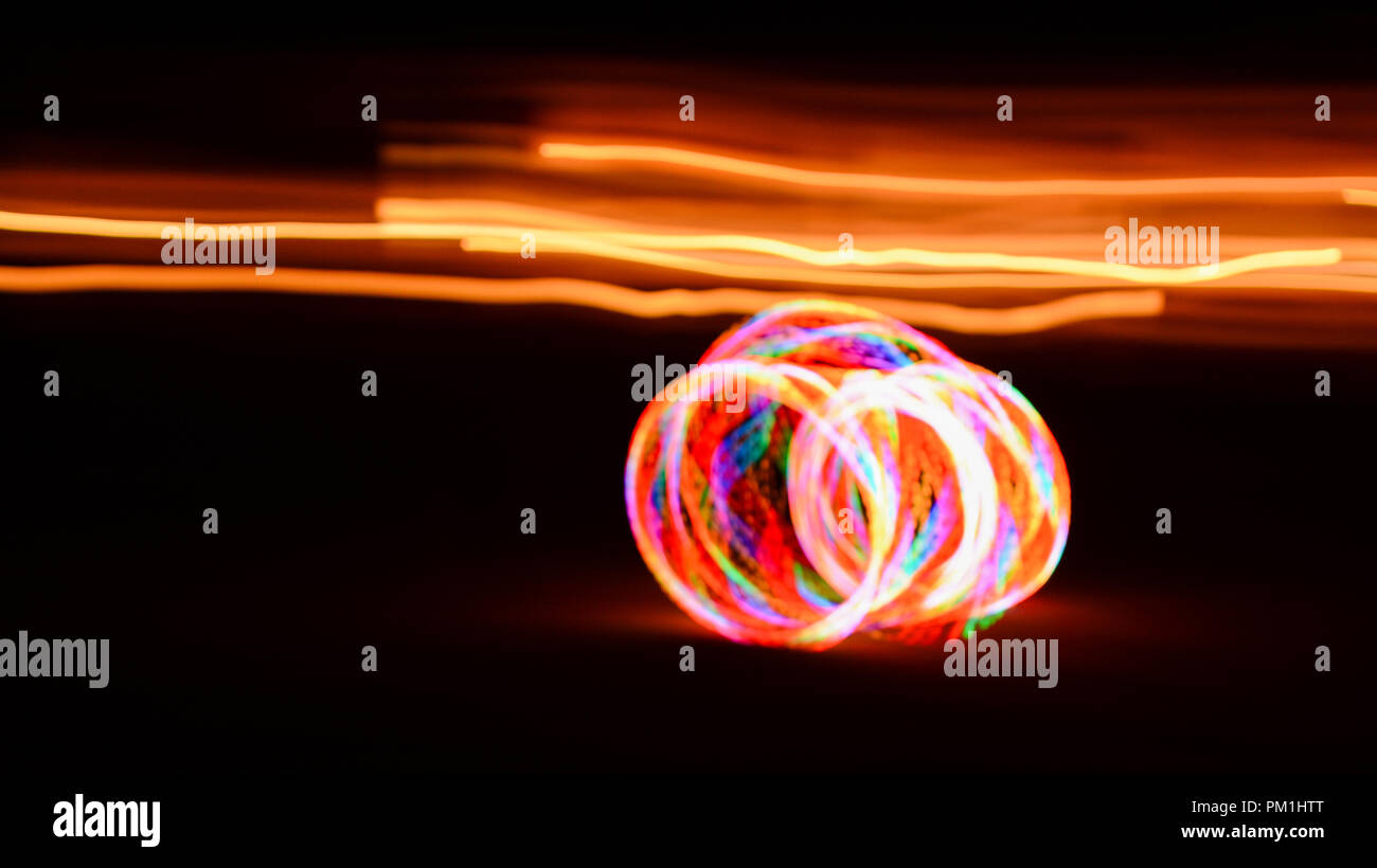 abstract pan of hoola hoop rolling night long exposure Stock Photo - Alamy