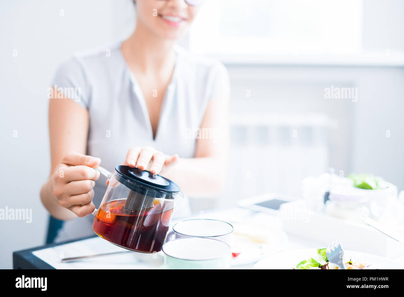 Hand pouring healthy herbal tea hi-res stock photography and images - Alamy