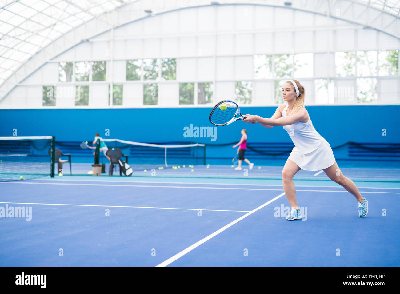 Blonde Woman Playing Tennis Action Shot Stock Photo - Alamy