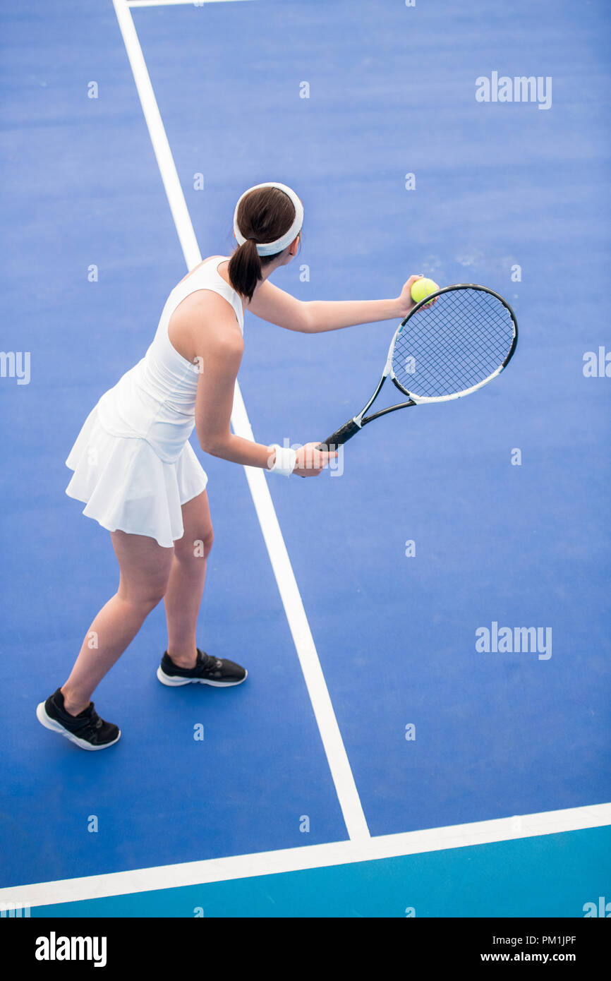 Tennis Player Serving Ball in Court Stock Photo - Alamy