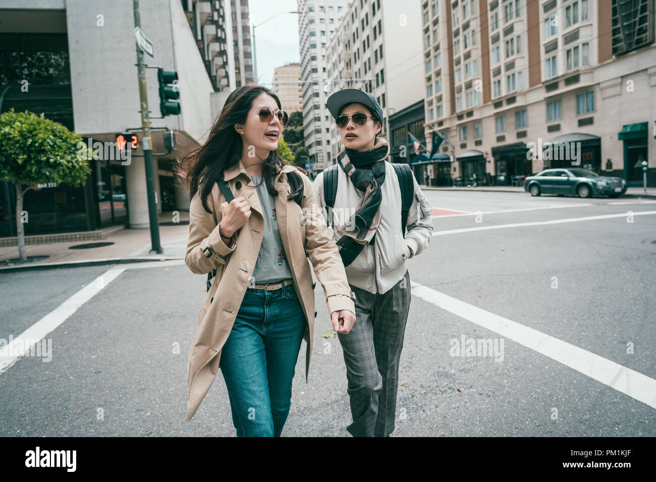 tow good friends walking across the road and hanging out with each ...