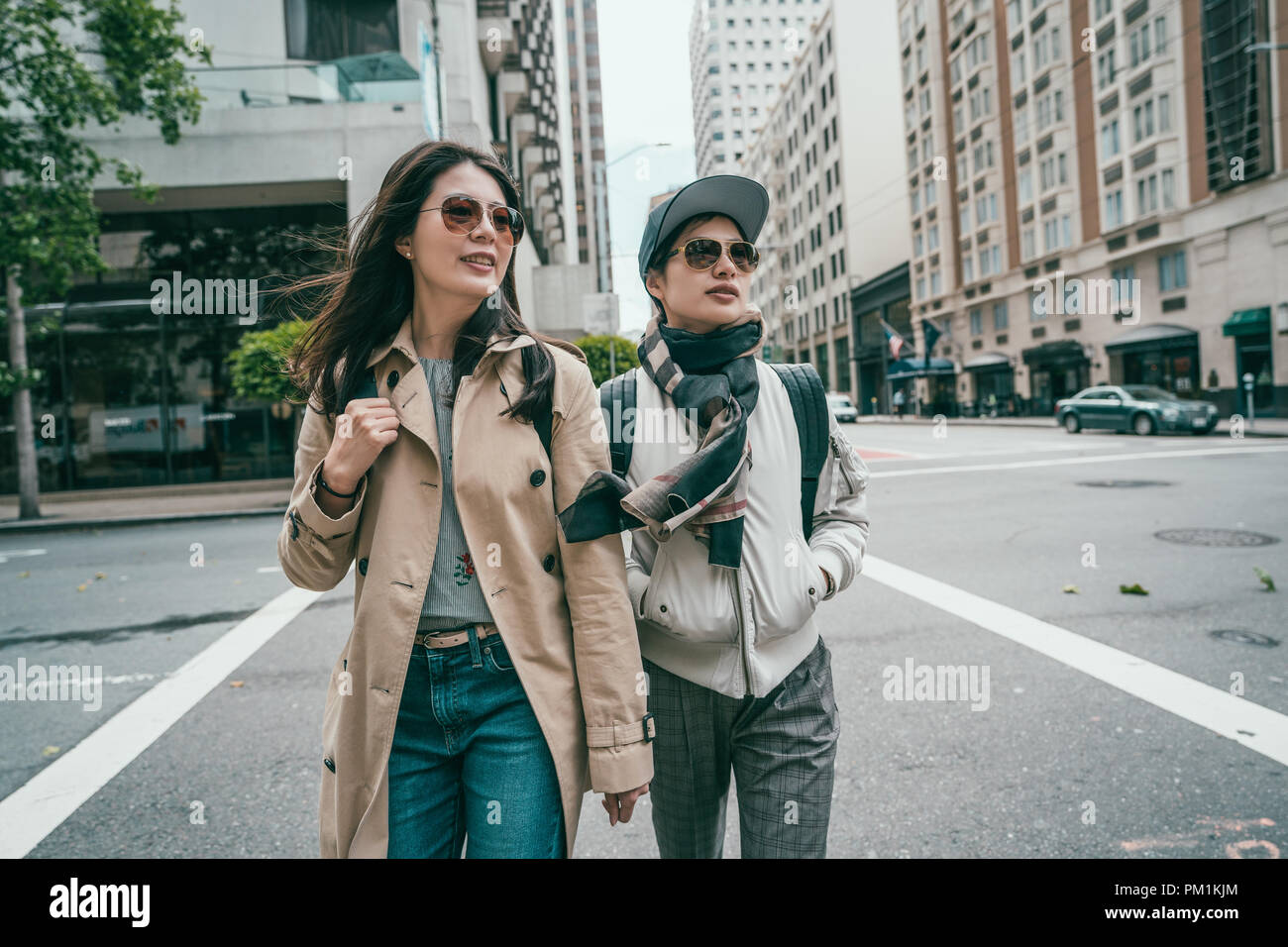 good friends walking in the street and hanging out together with ...