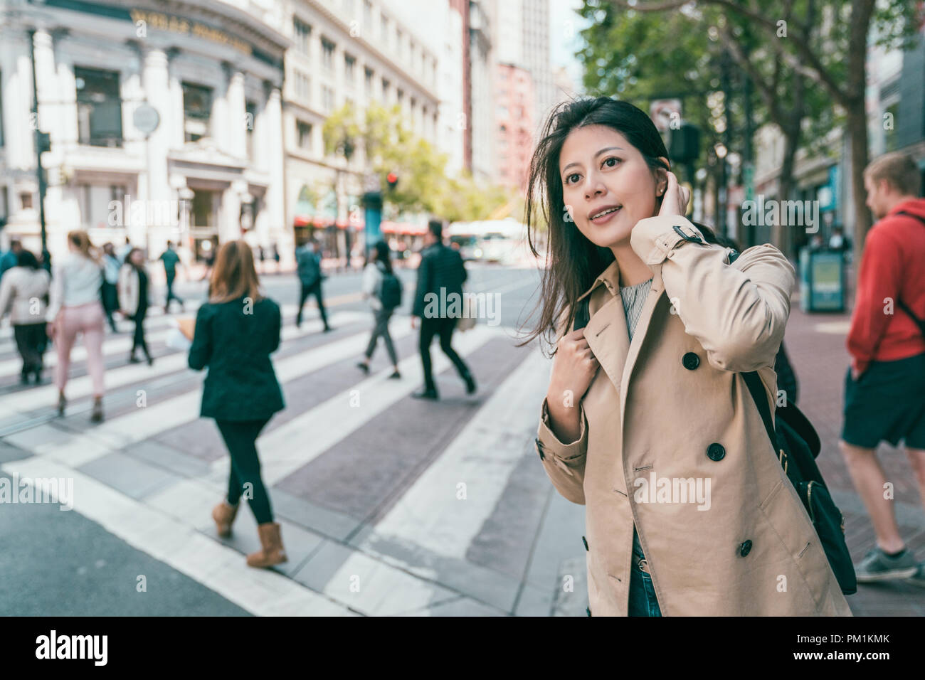 pretty woman looking around the city joyfully by the background of ...