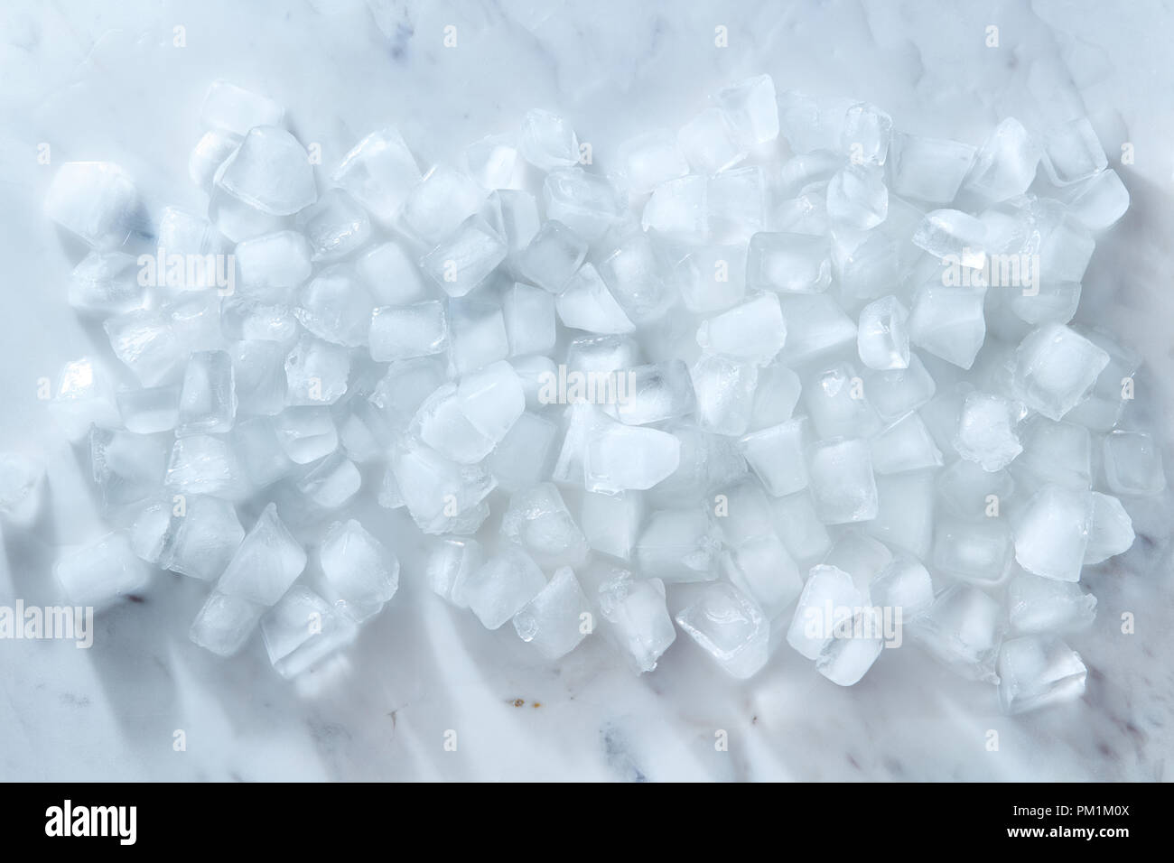 Cubes of ice on a gray marble table. Concept of a cold summer drink ...