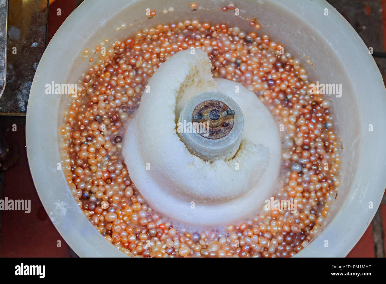 Pearls being cleaned in a pearl mill centrifuge for sale at the market ...