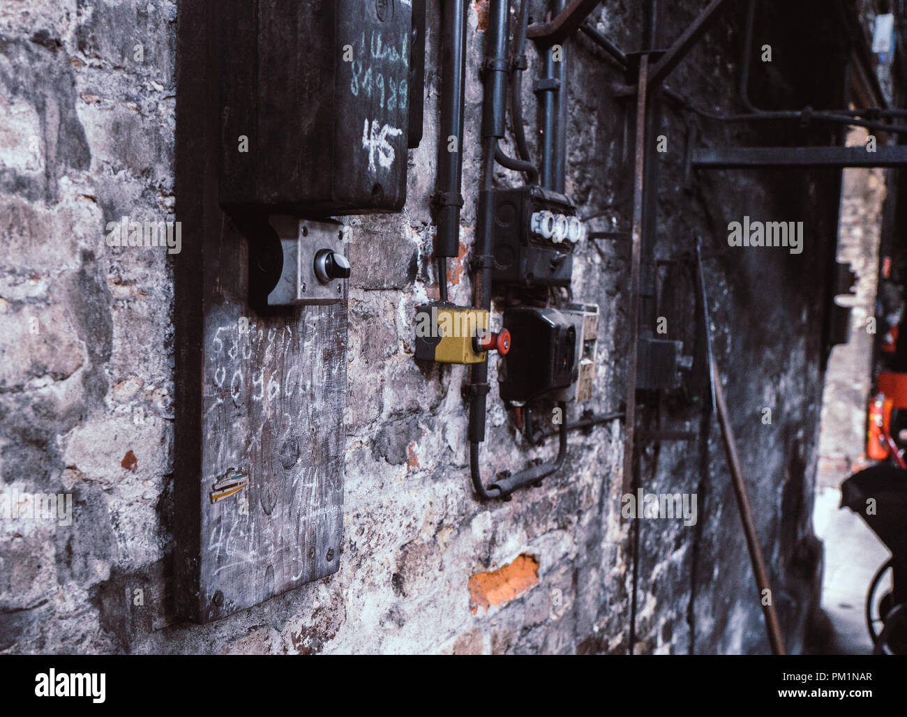 wall with installations in an old factory Stock Photo - Alamy